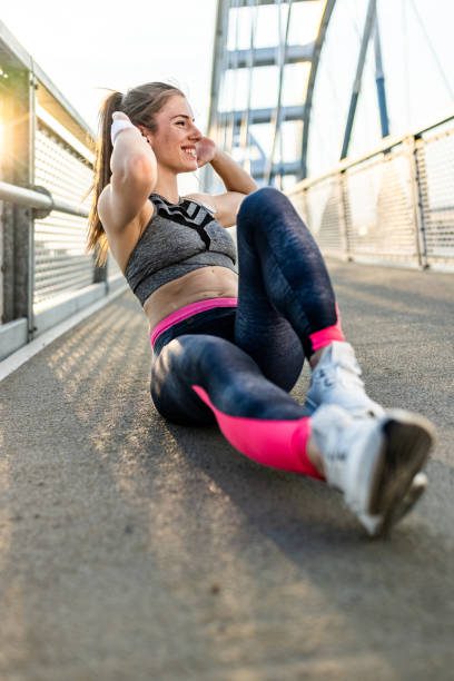 Sporty young woman doing bicycle crunch sit-up exercise - Morning Lazziness